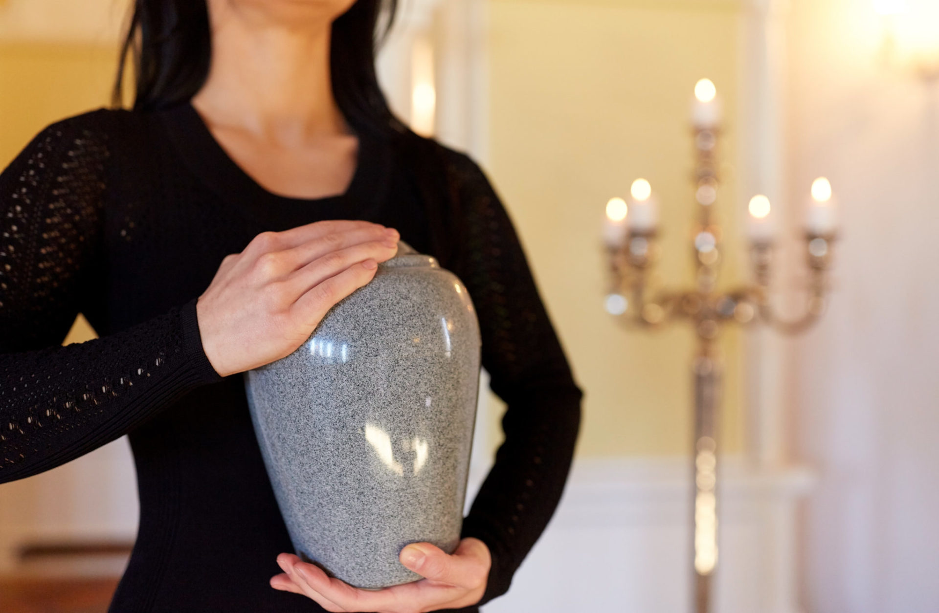 Close Up Of Woman With Cremation Urn In Church - Daniel Funeral Home ...